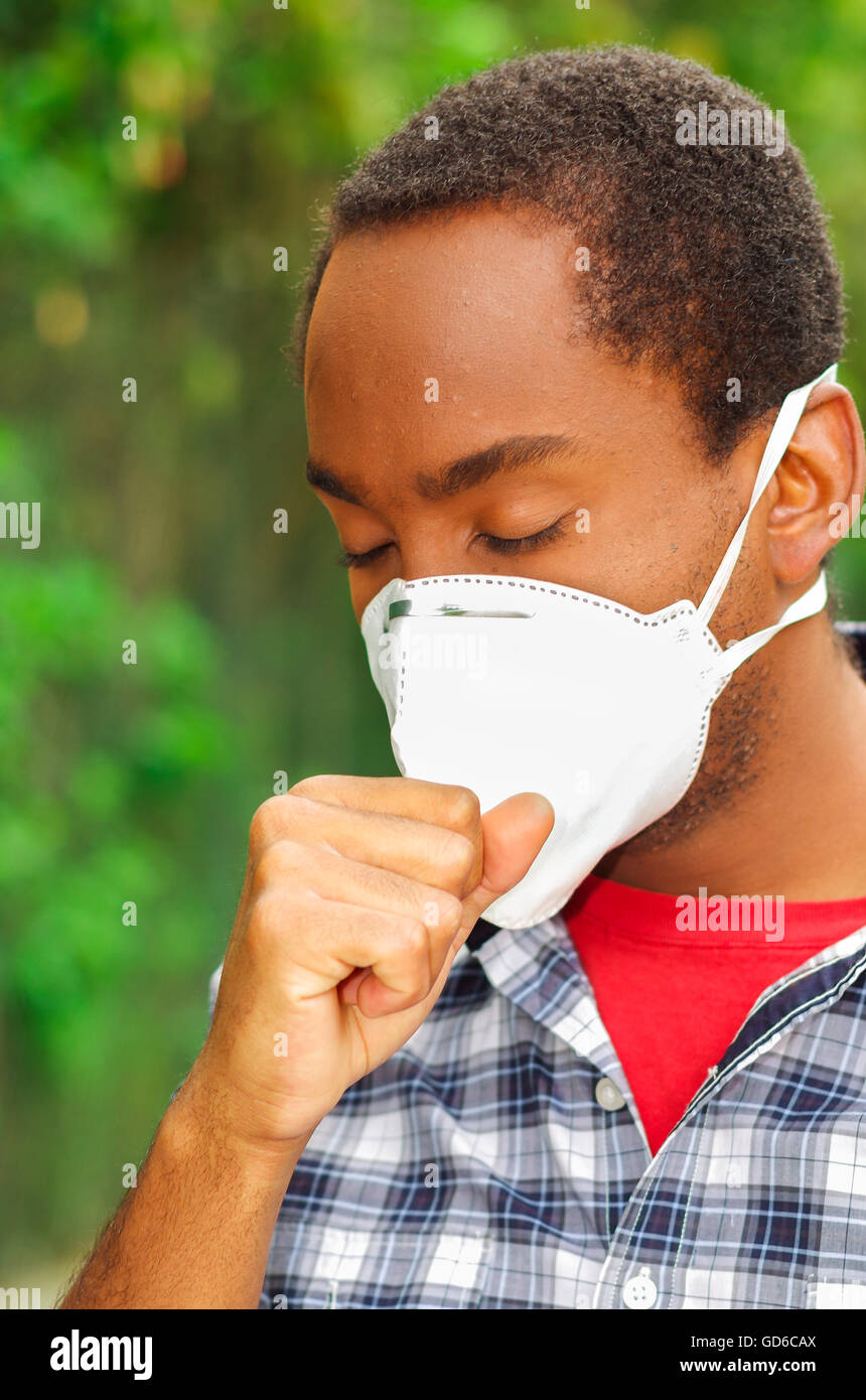 Closeup man headshot covering nose and mouth with protection filter ...
