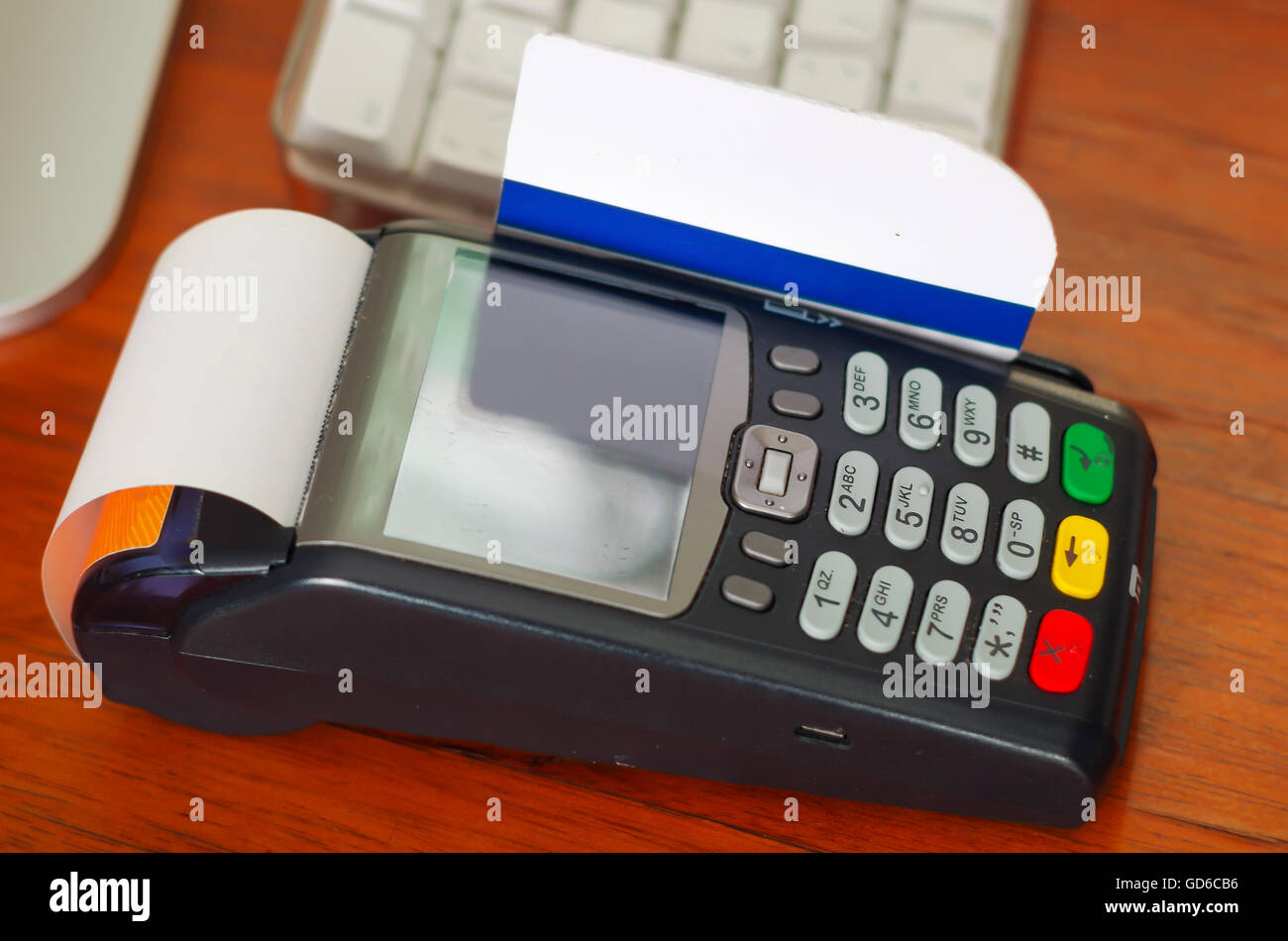 Closeup credit card payment terminal device with receipt paper sticking ...