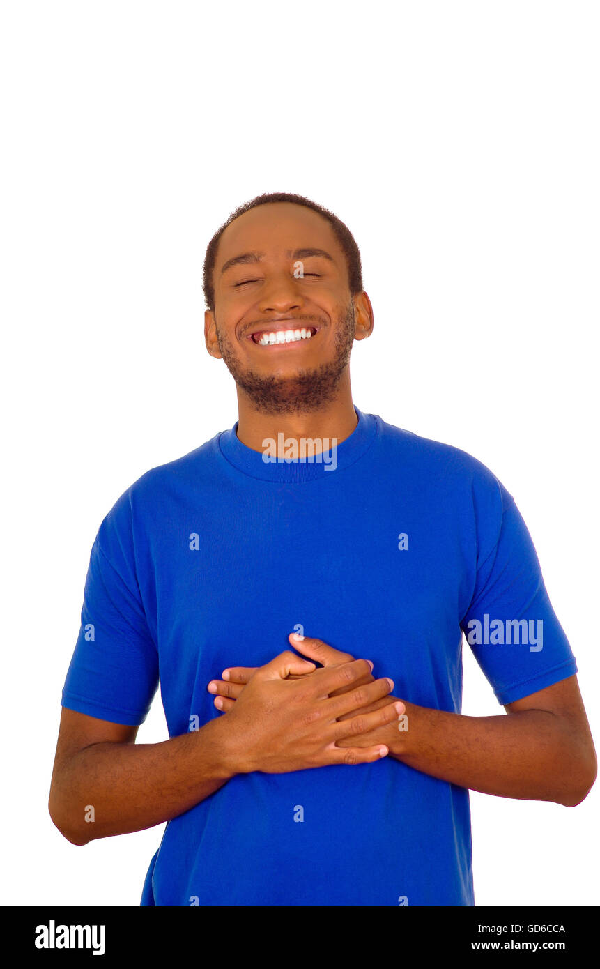 Man wearing strong blue t-shirt standing and laughing hard holding his ...