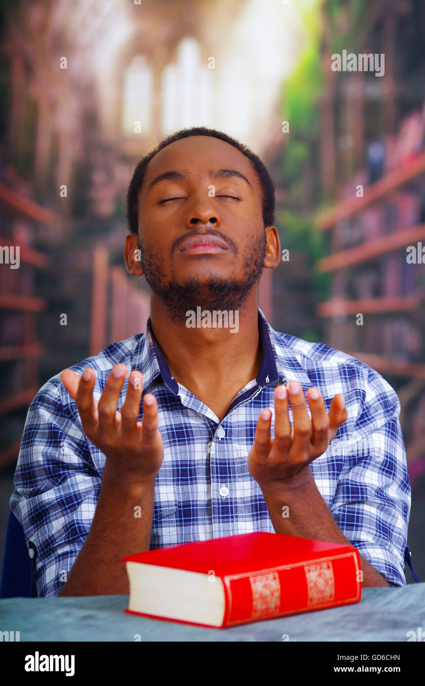 Man praying in front of cross hi-res stock photography and images - Alamy
