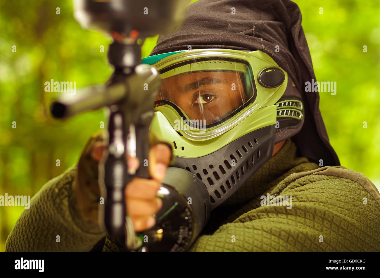 Closeup headshot man wearing green and black protection facial mask ...