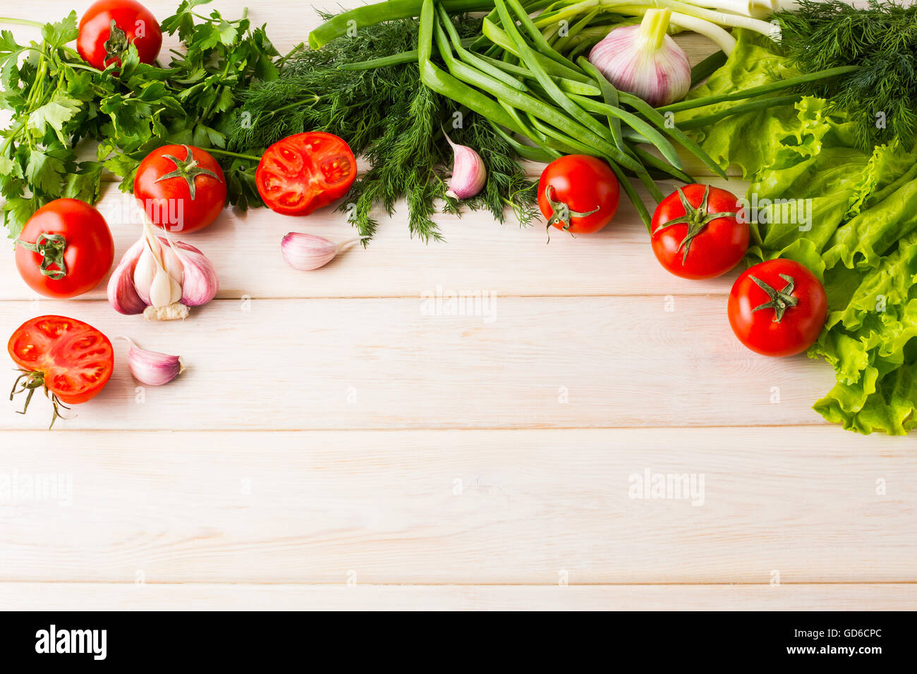 Fresh vegetables on the white wooden background. Healthy eating ...