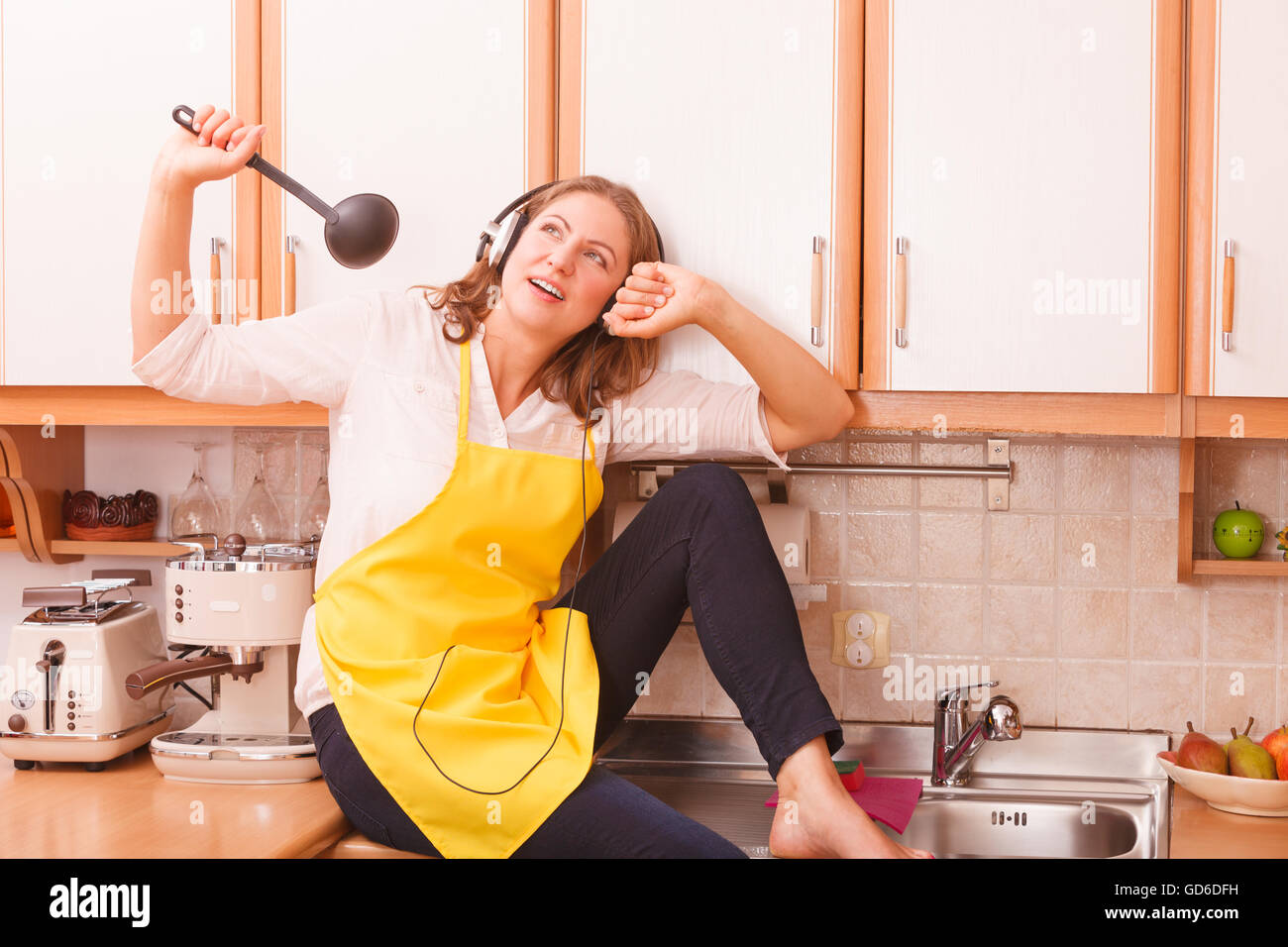 Relax in kitchen. Listening music singing and dancing. Funny happy ...