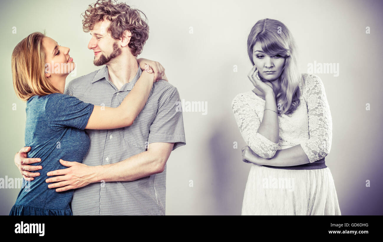 Jealousy and betrayal concept. Abandoned unloved girl watching on happy ...