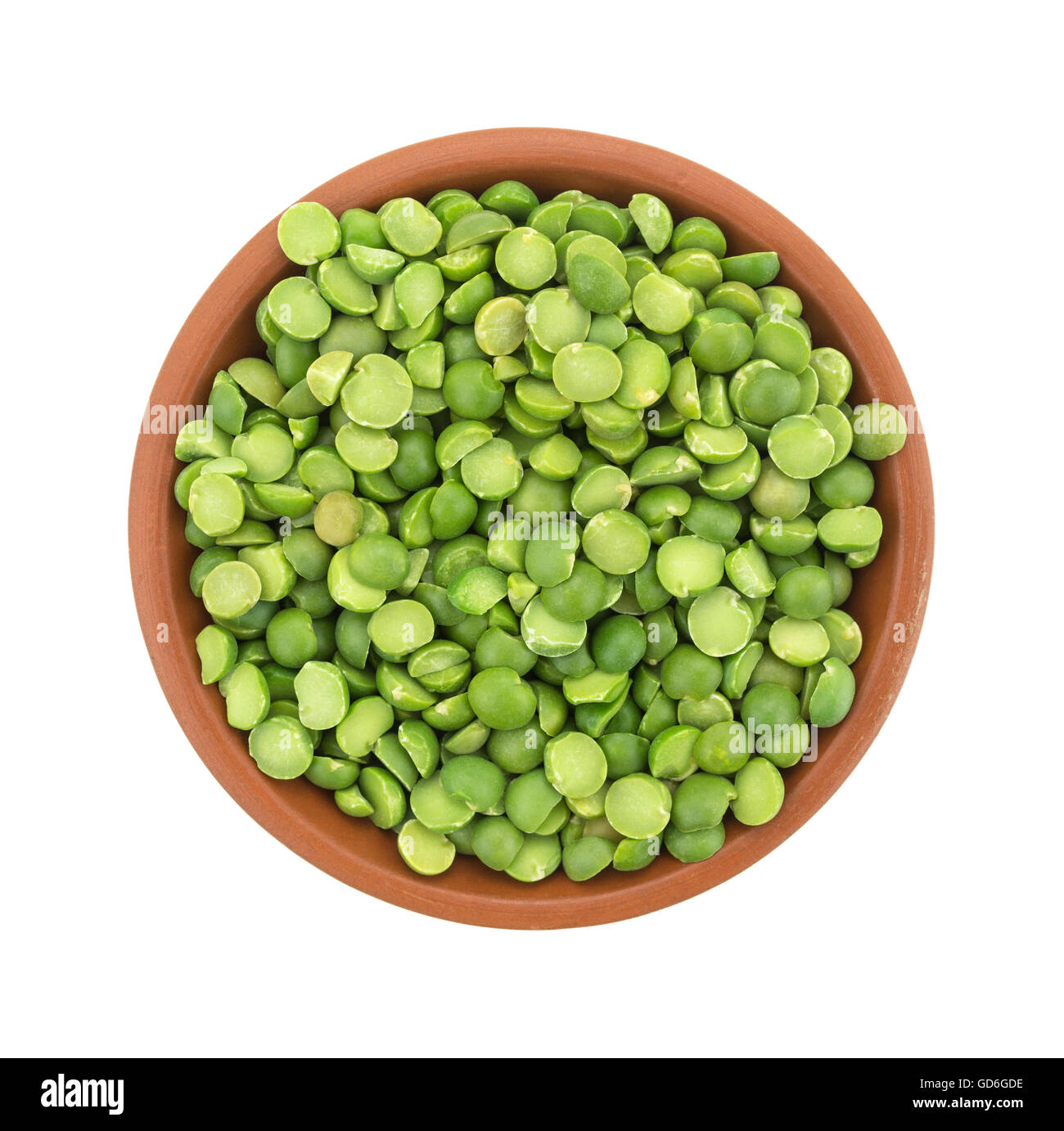 Top view of organic green split peas filling a small bowl isolated on a ...
