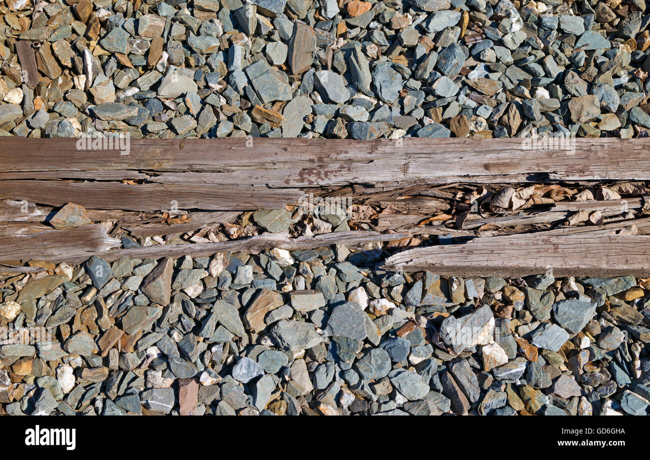 A rotting railroad tie with ballast on either side Stock Photo - Alamy