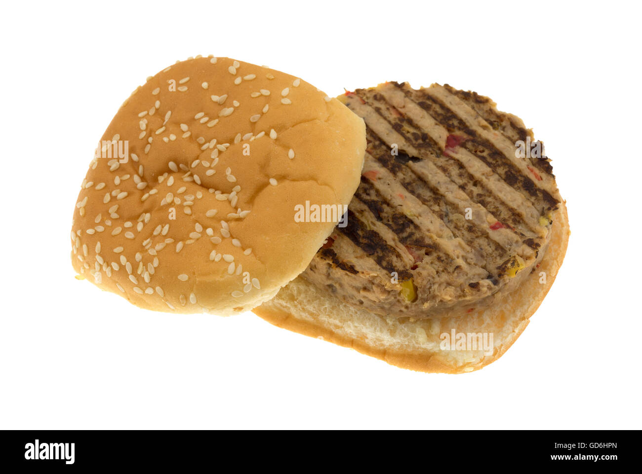 An opened faced veggie burger in a bun isolated on a white background ...