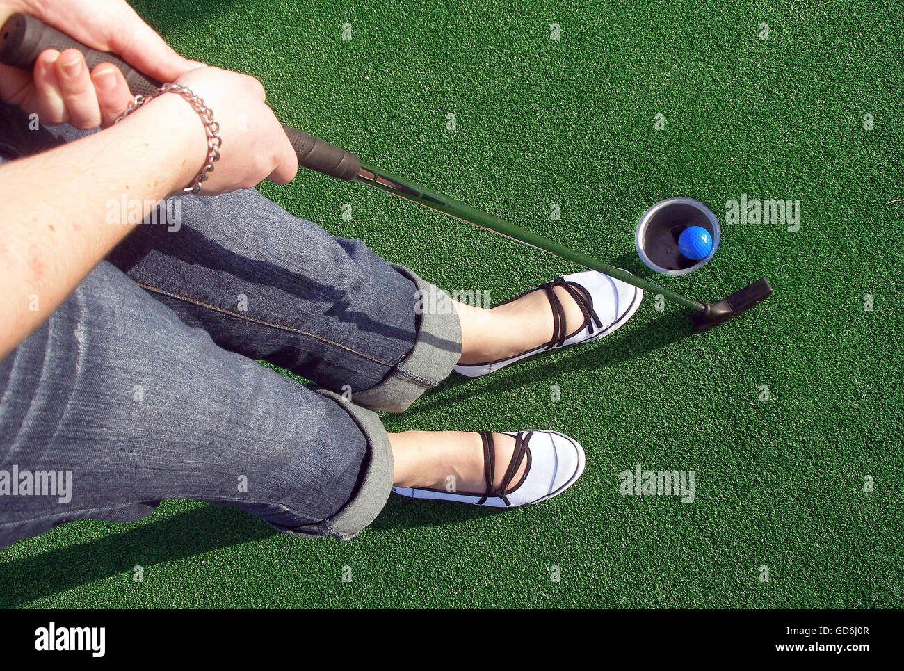 Putting a ball at an adventure golf Stock Photo - Alamy