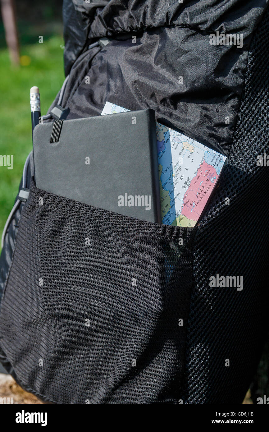 Backpack with tourist equipment, closeup. Black Backpack with map ...
