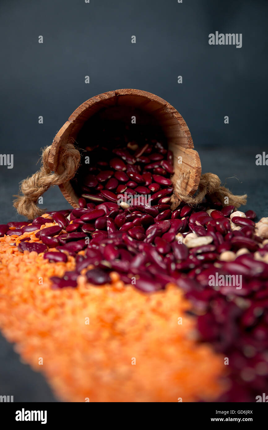 Group of beans and lentils wooden cup on black background. beans ...