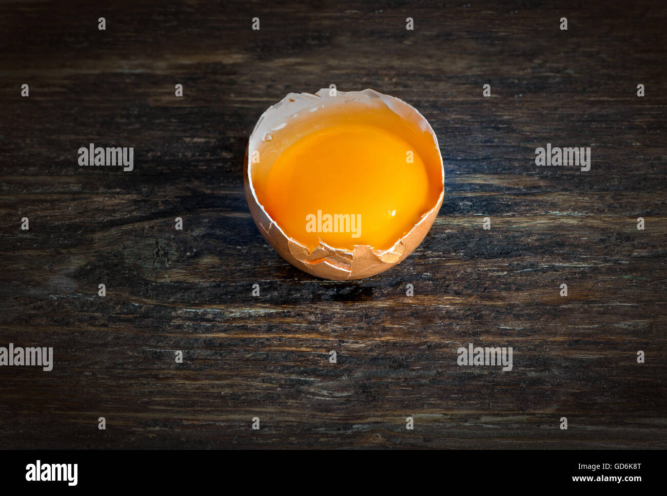 Raw egg in shell on rustic wooden background Stock Photo - Alamy