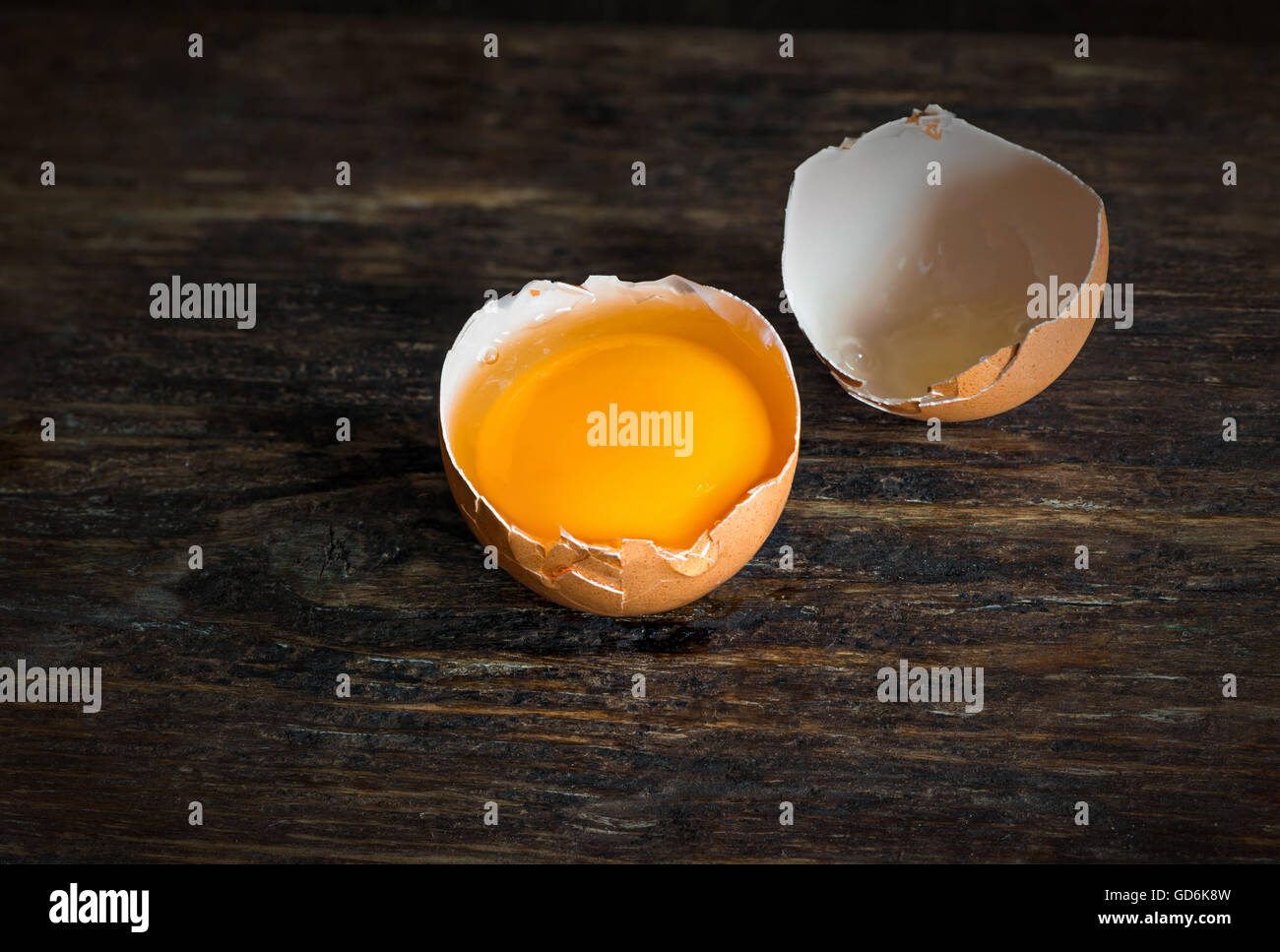 Raw egg in shell on rustic wooden background Stock Photo - Alamy