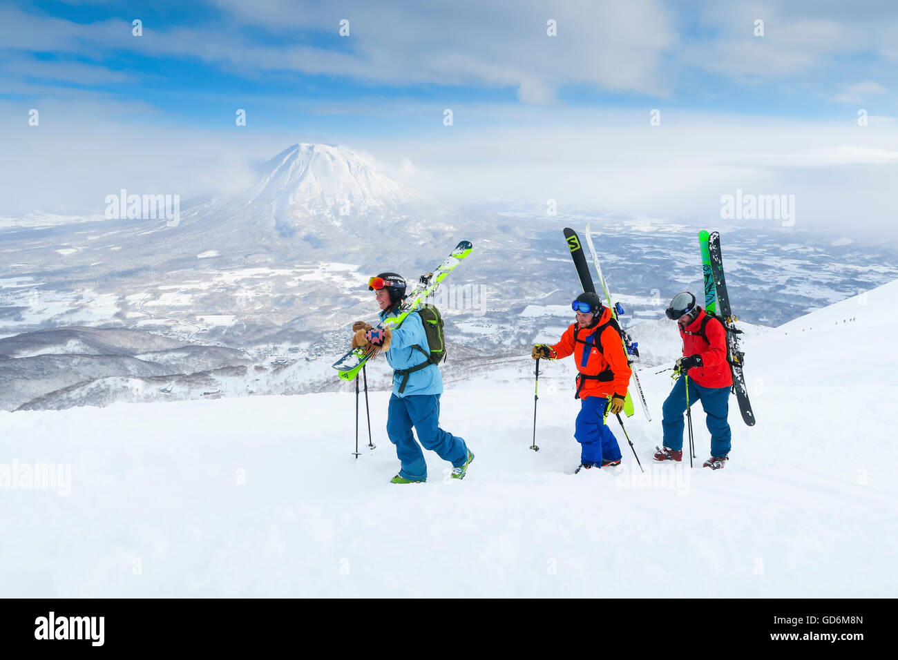 With the volcano Yotei in the background a female and two male ...