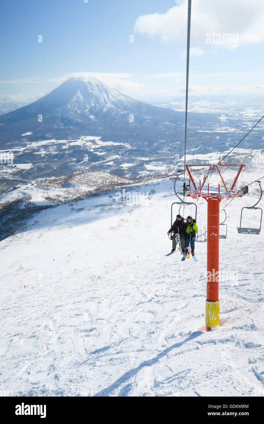 With the volcano Yotei in the background a female and male backcountry ...