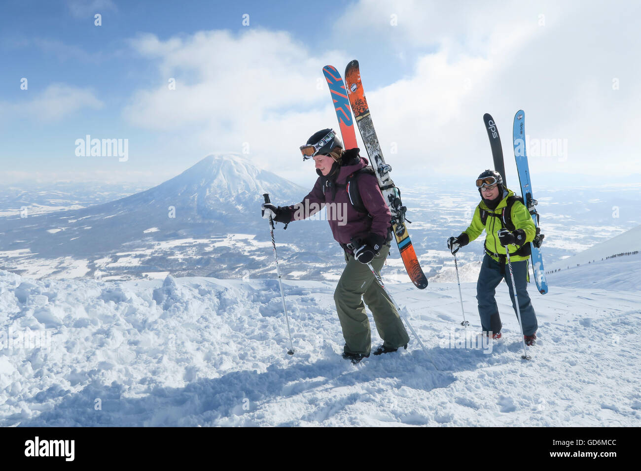 With the volcano Yotei in the background a female and male backcountry ...