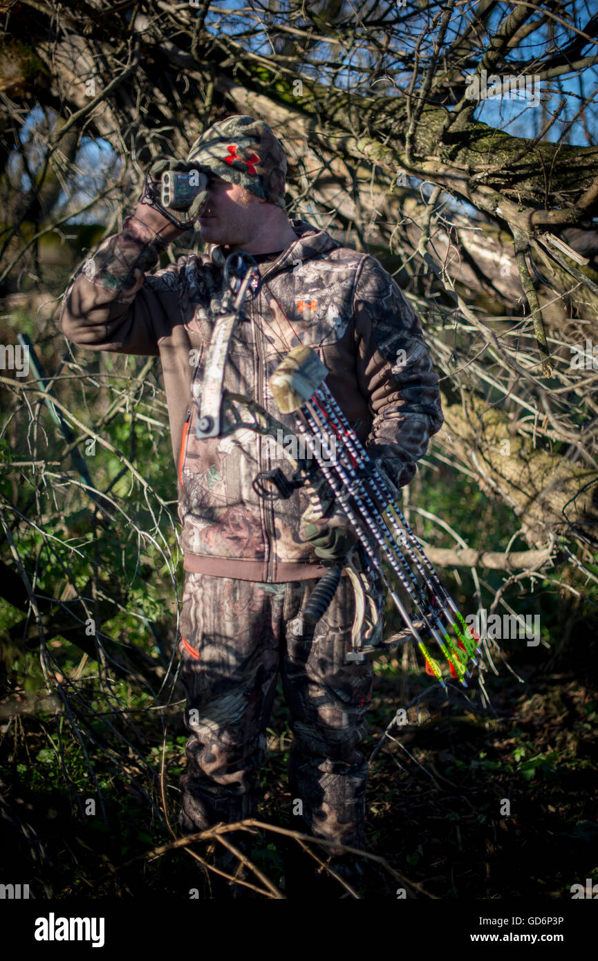 Young adult male searching for deer while bow hunting in Illinois Stock ...