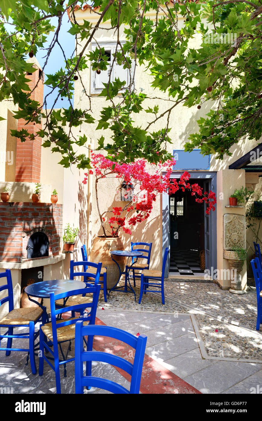 The amphora with flowers and traditional Greek table and chairs at ...