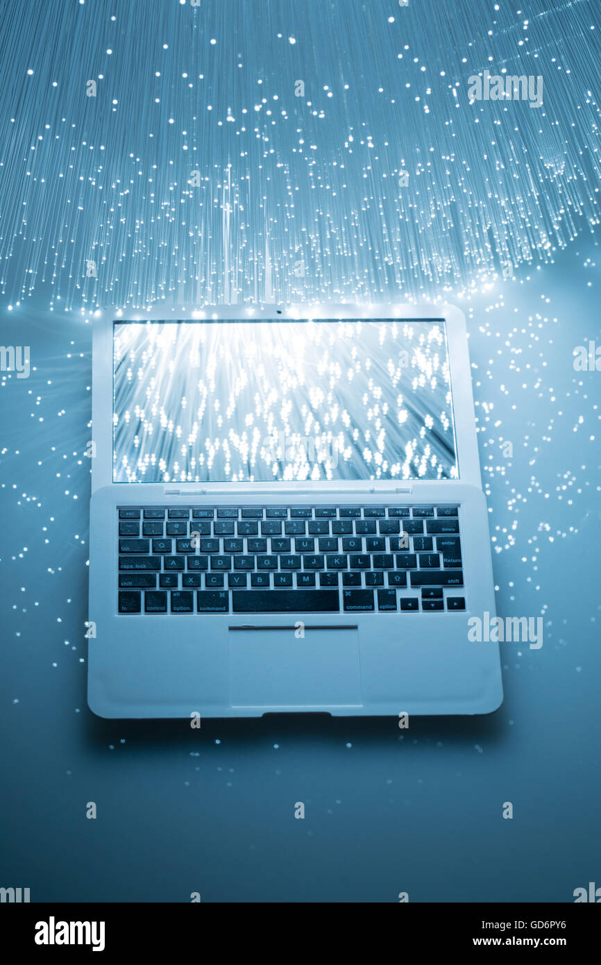 Notebook computer and Fiber optics background Stock Photo - Alamy