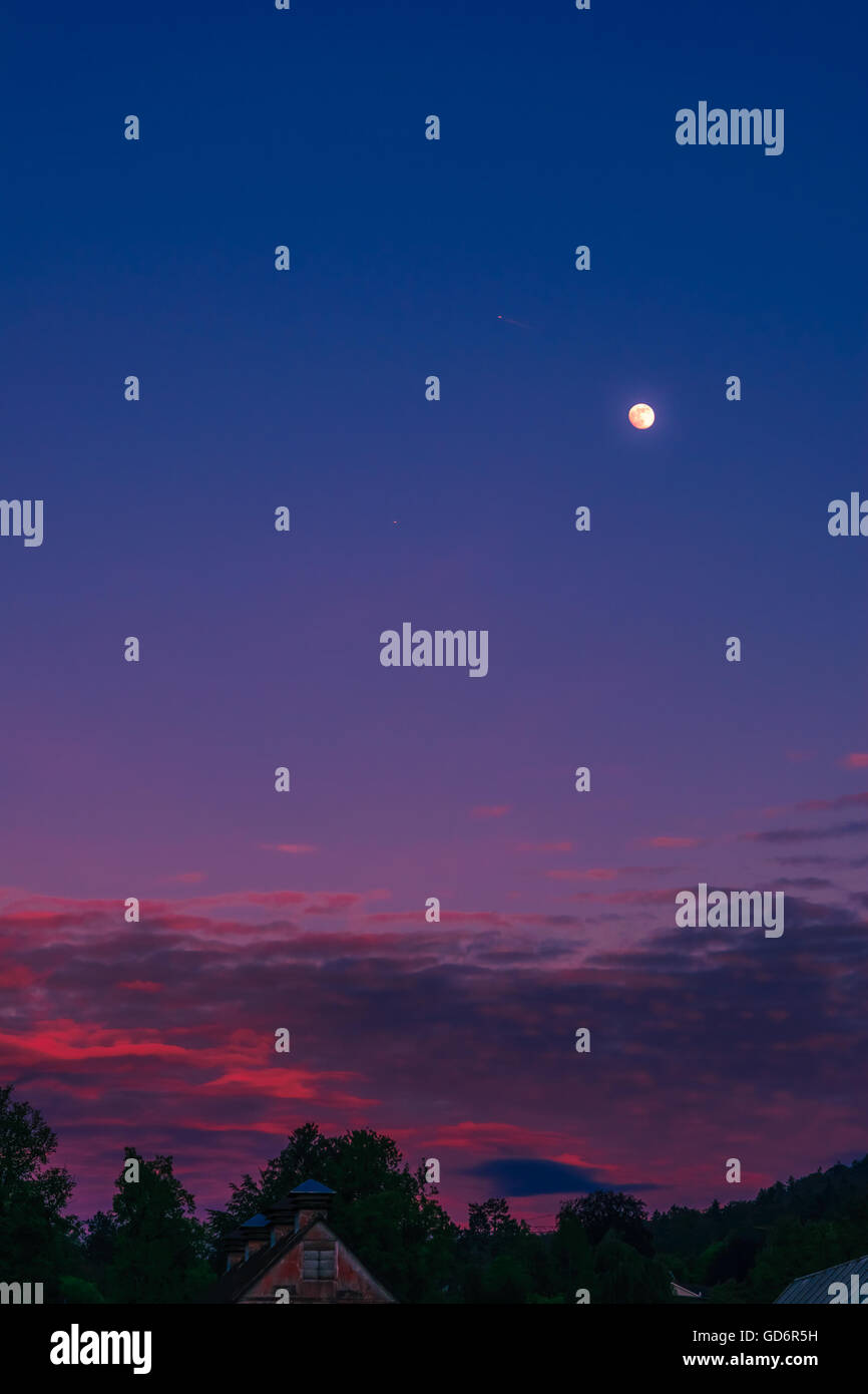 Moon up on colourful sky Stock Photo - Alamy