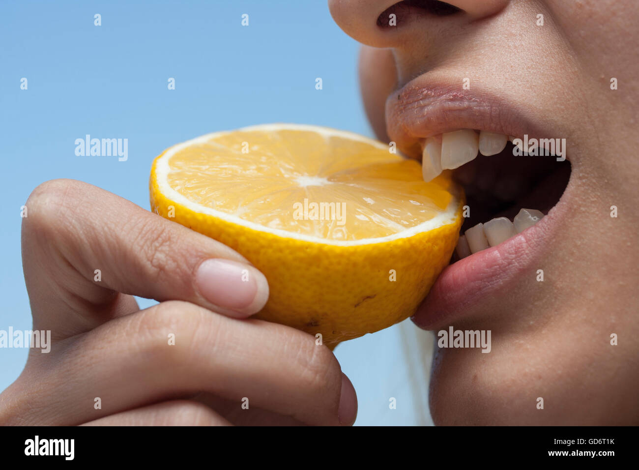 Woman Eating Lemon Stock Photo - Alamy