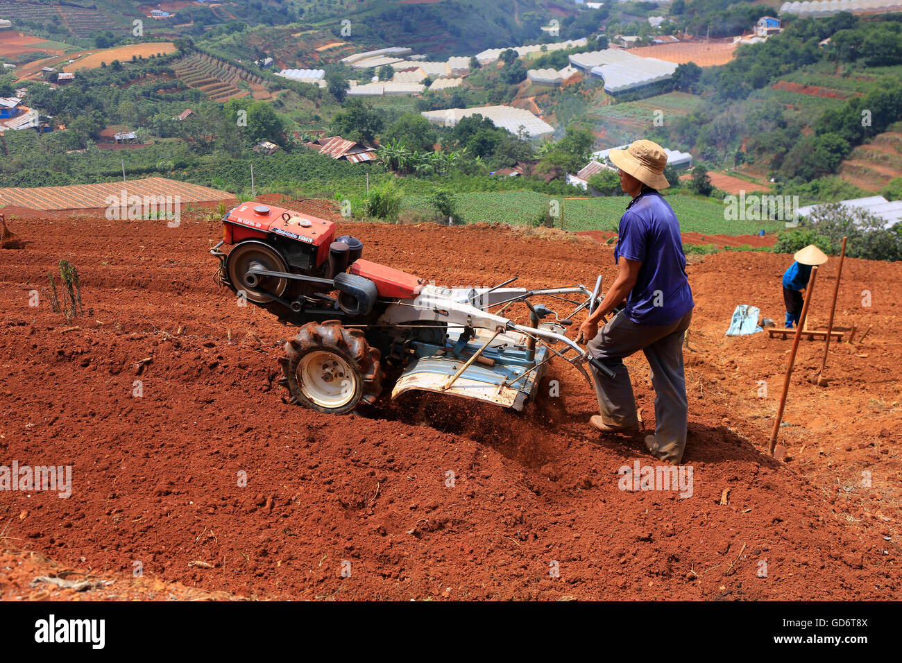 Farmer preparing soil in field Stock Photo - Alamy