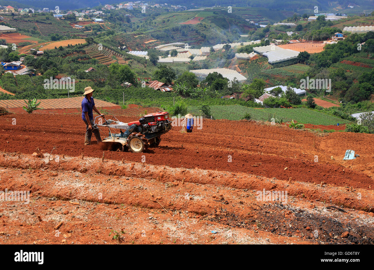 Farmer preparing soil in field Stock Photo - Alamy