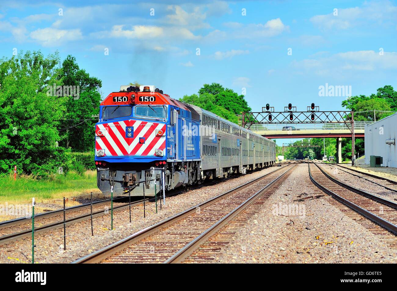 West Chicago, Illinois, USA. A Metra locomotive pushing an eastbound ...