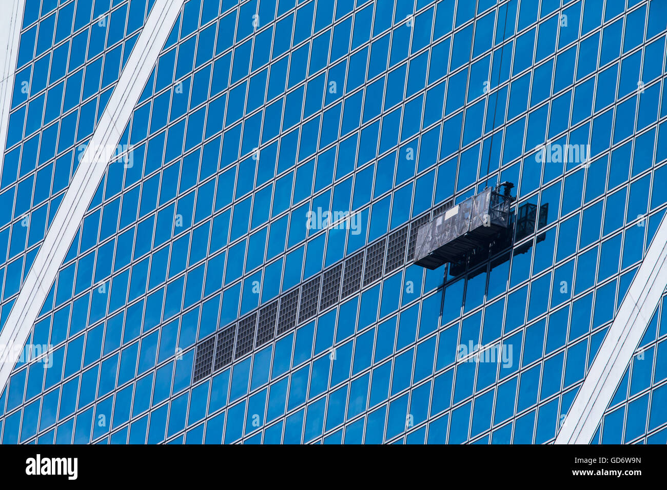 Suspended working platforms on blue building Stock Photo - Alamy