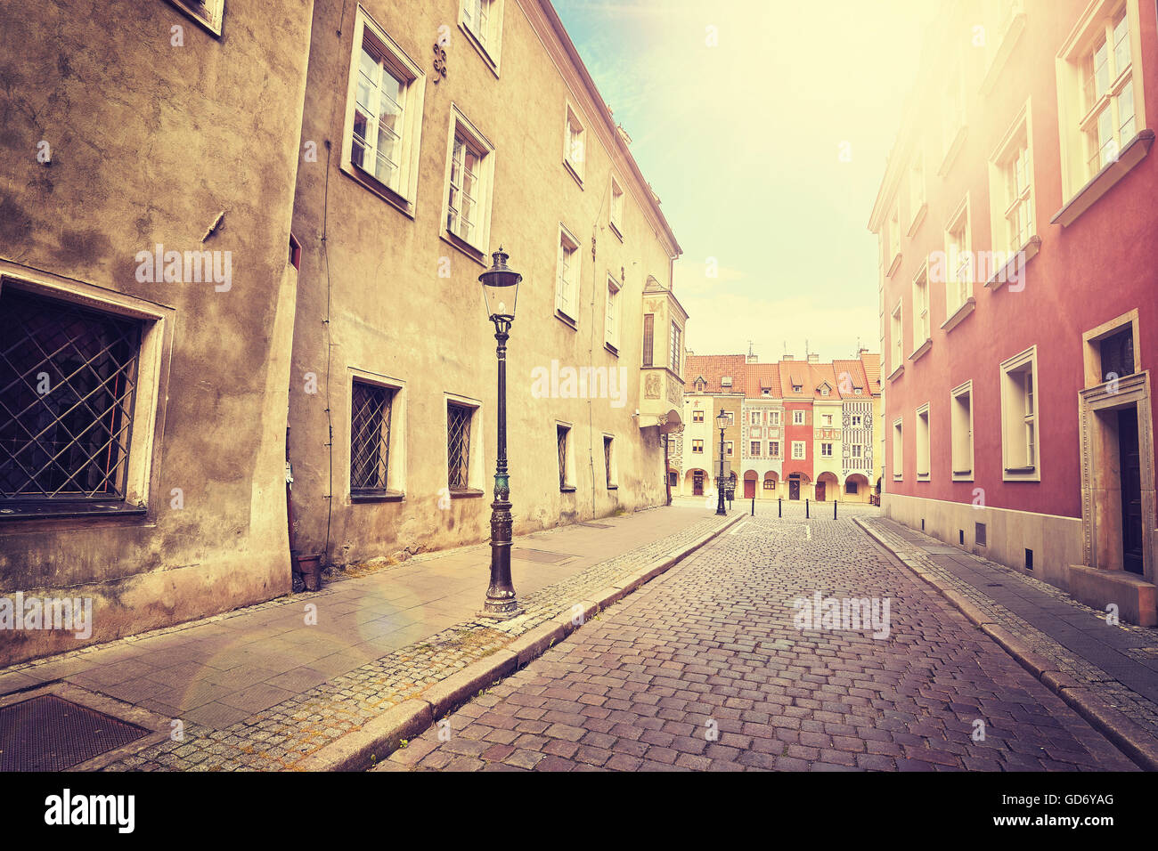 Vintage stylized street in Poznan old town with lens flare effect ...