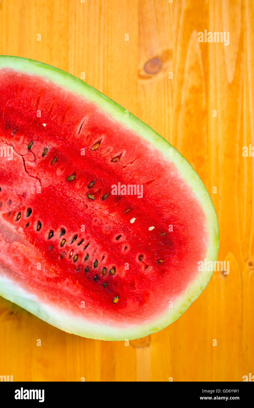 Watermelon cross section slice on wooden table, top view, selective ...