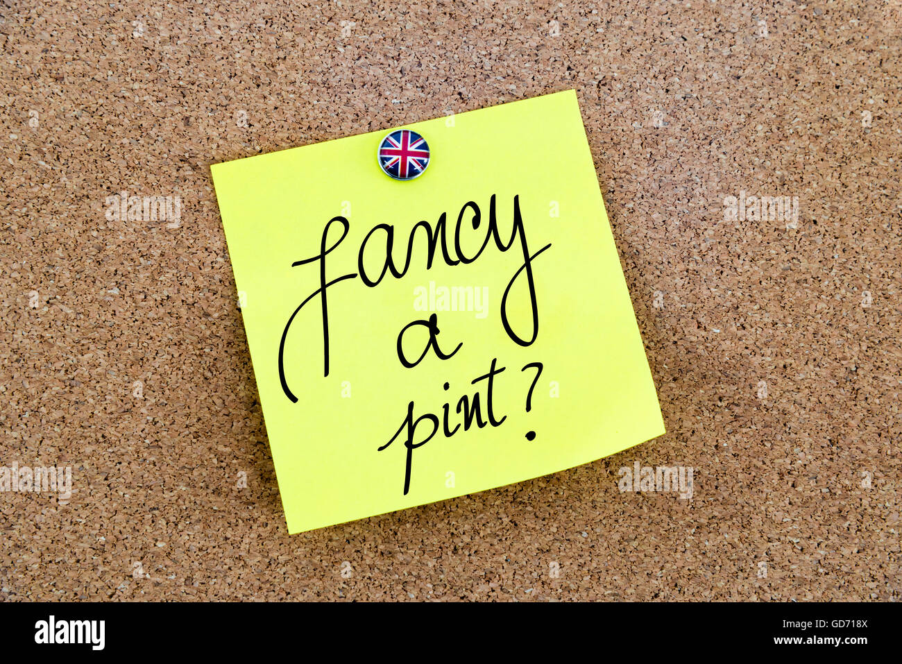 Yellow paper note pinned on cork board with Great Britain flag ...