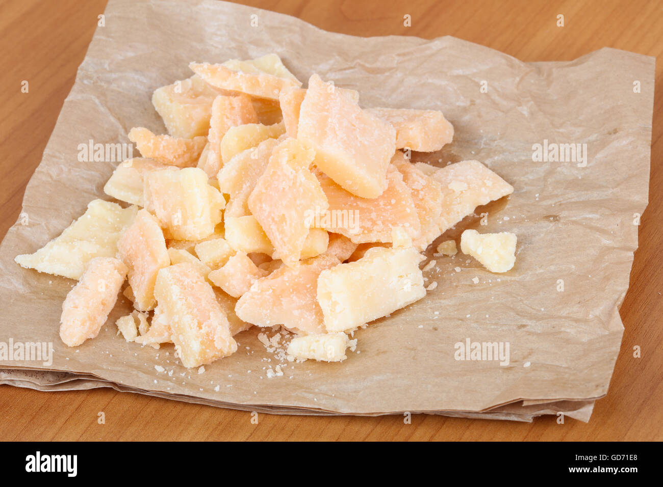 Cutting parmesan cheese crunches on the wood background Stock Photo - Alamy