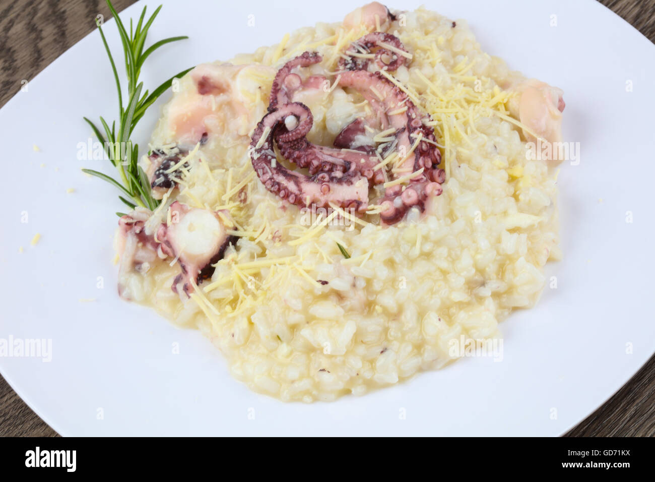 Risotto with octopus served green rosemary Stock Photo - Alamy