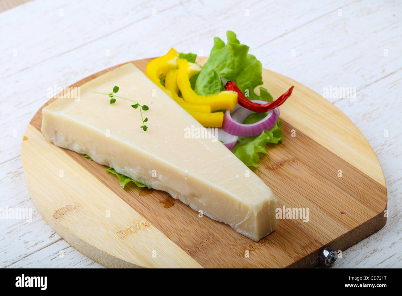 Parmesan cheese triangle on the wood background Stock Photo - Alamy