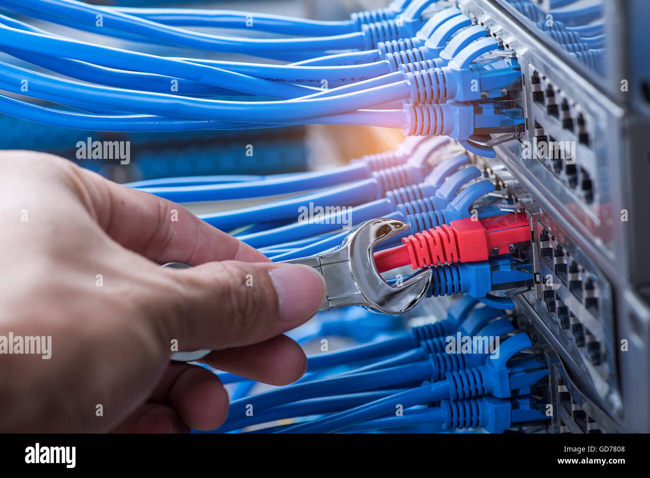 man Repair network cable to switch with wrench Stock Photo - Alamy