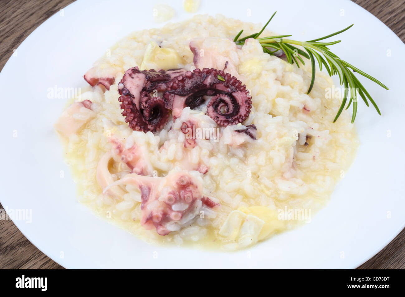 Risotto with octopus served green rosemary Stock Photo - Alamy