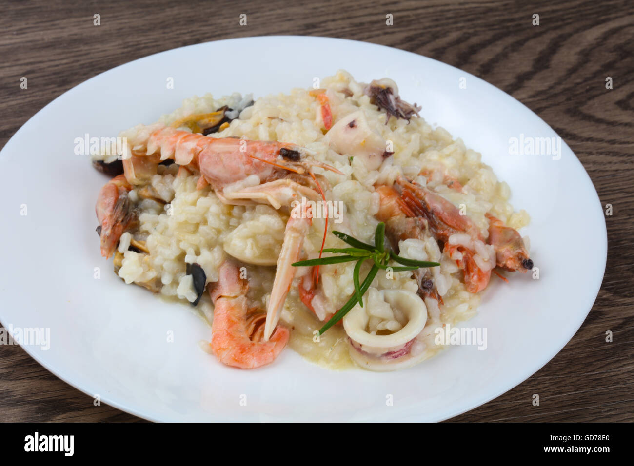 Seafood mix risotto with rosemary leaves Stock Photo - Alamy
