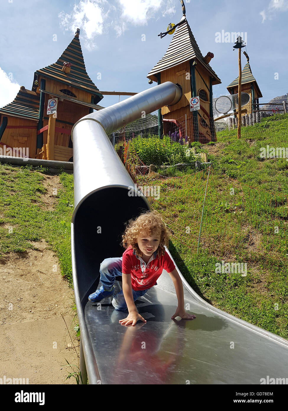 Boy happily playing on a playground in the mountains Stock Photo - Alamy