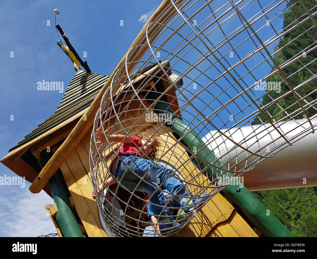Boy happily playing on a playground in the mountains Stock Photo - Alamy