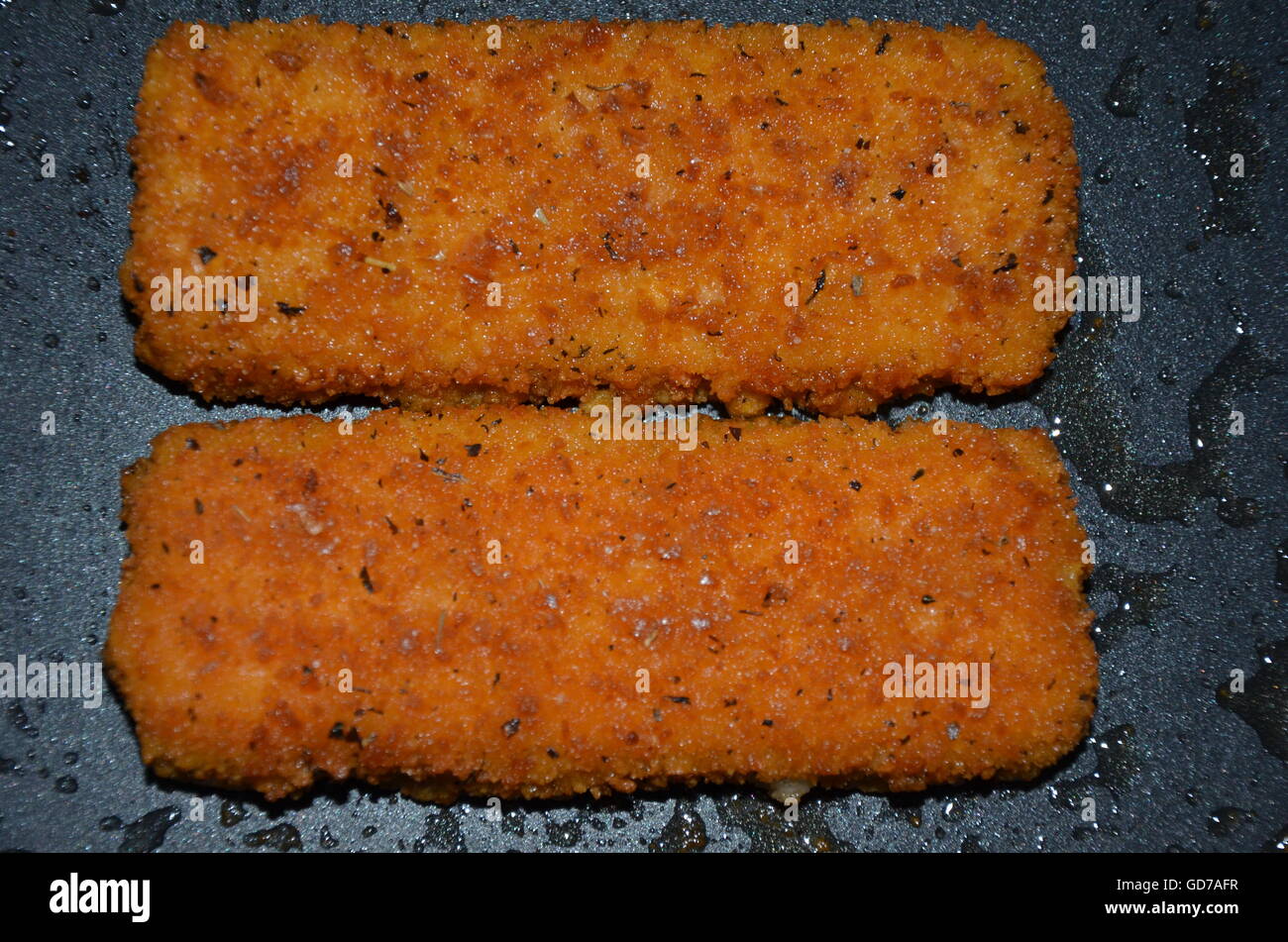Grilled, fish, finger, fry pane, oil, black background Stock Photo - Alamy