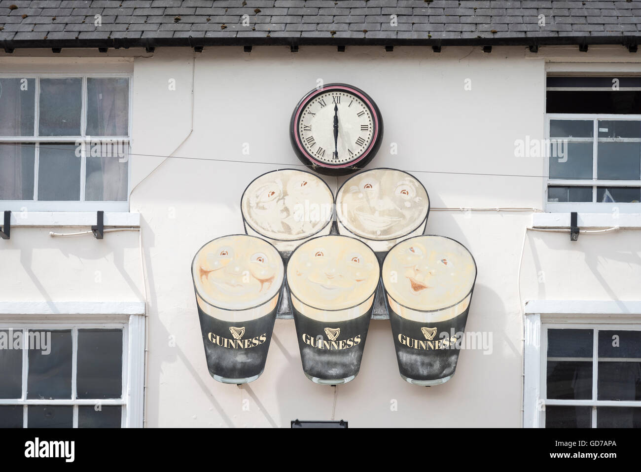 A wall mounted guiness advertisement on a pub wall in Wellingborough UK ...