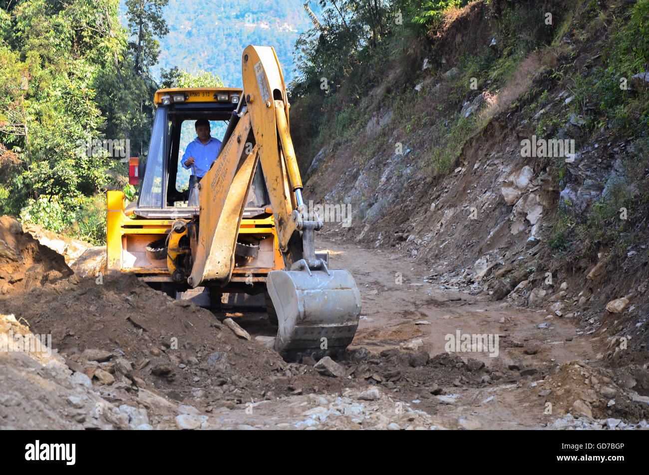 Bulldozer clearing mudflow from landslide on the road to Gangtok from ...