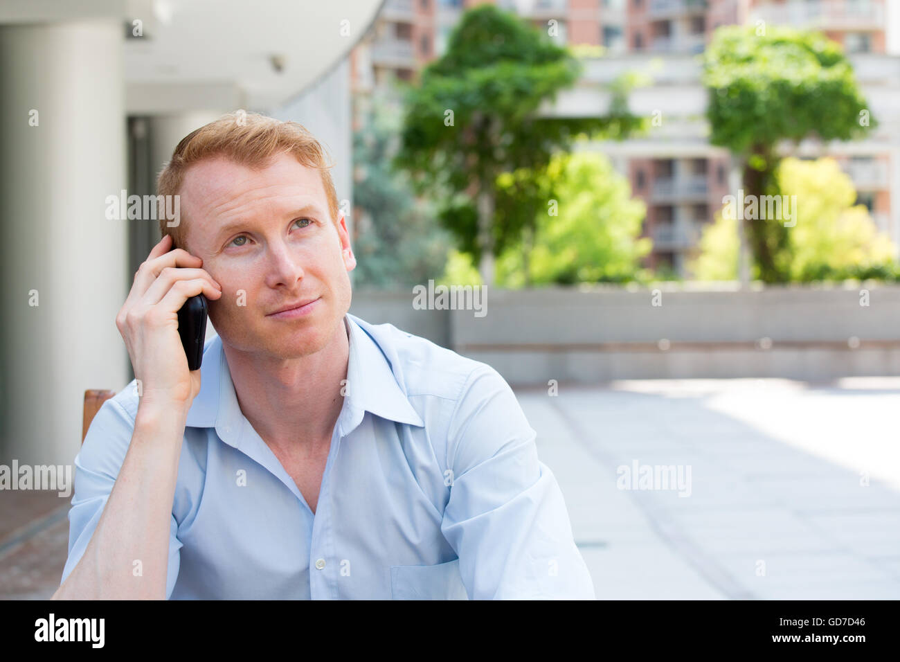 Closeup portrait, young man listening to conversation on cell phone ...