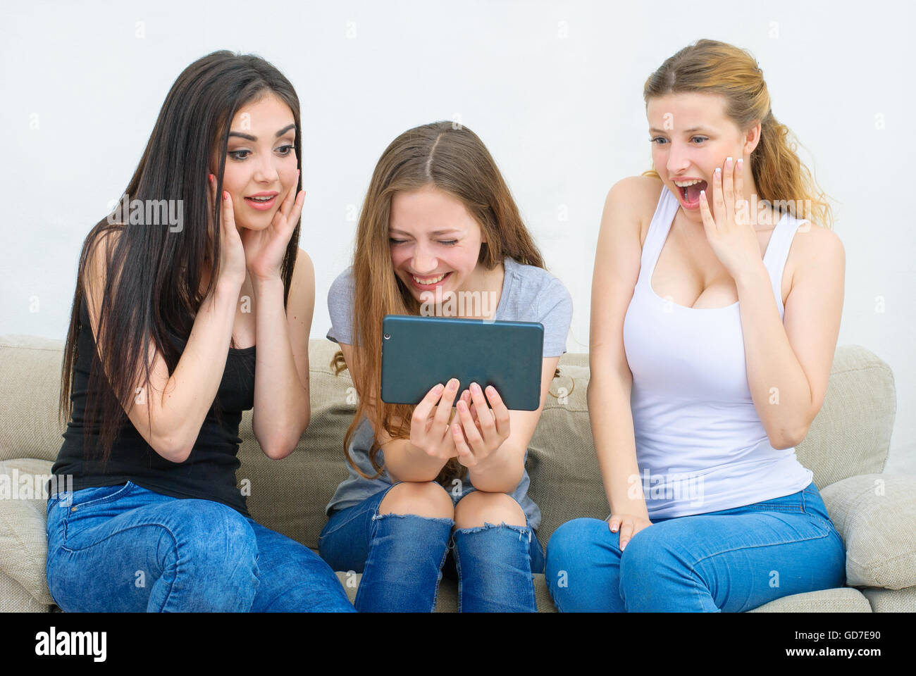 home, technology and friendship concept - three smiling girl Stock ...