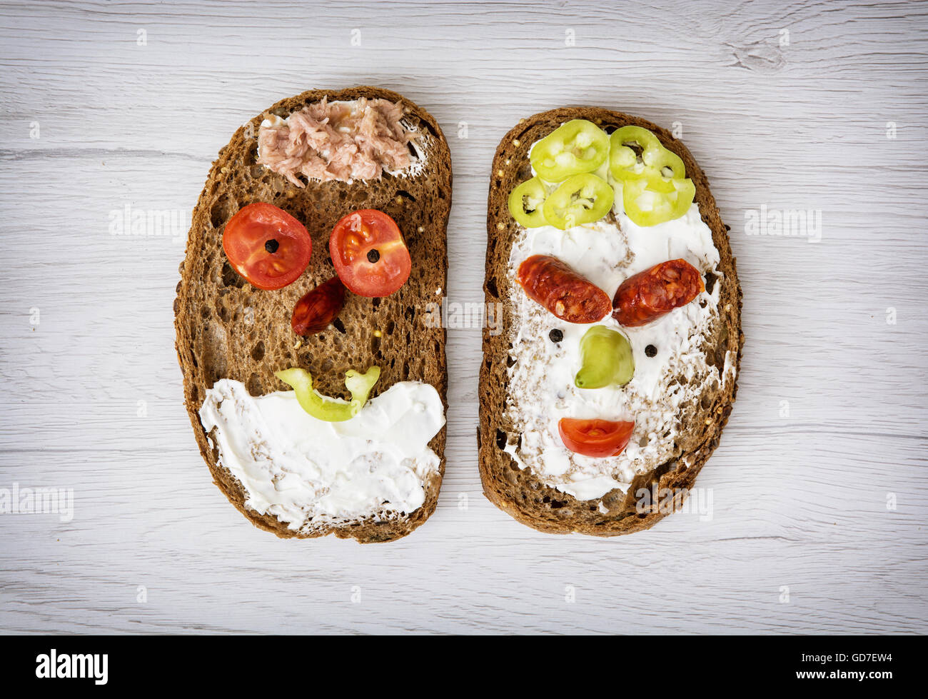 Two Funny Faces Made Of Bread Butter Tuna Sausage Paprika Tomato