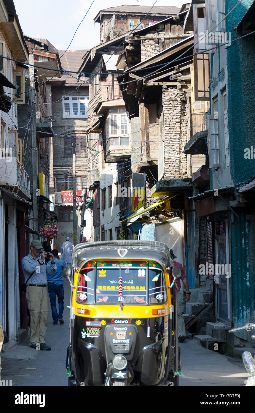 Tuk-tuk in narrow street with old buildings, Srinagar, Jammu and ...