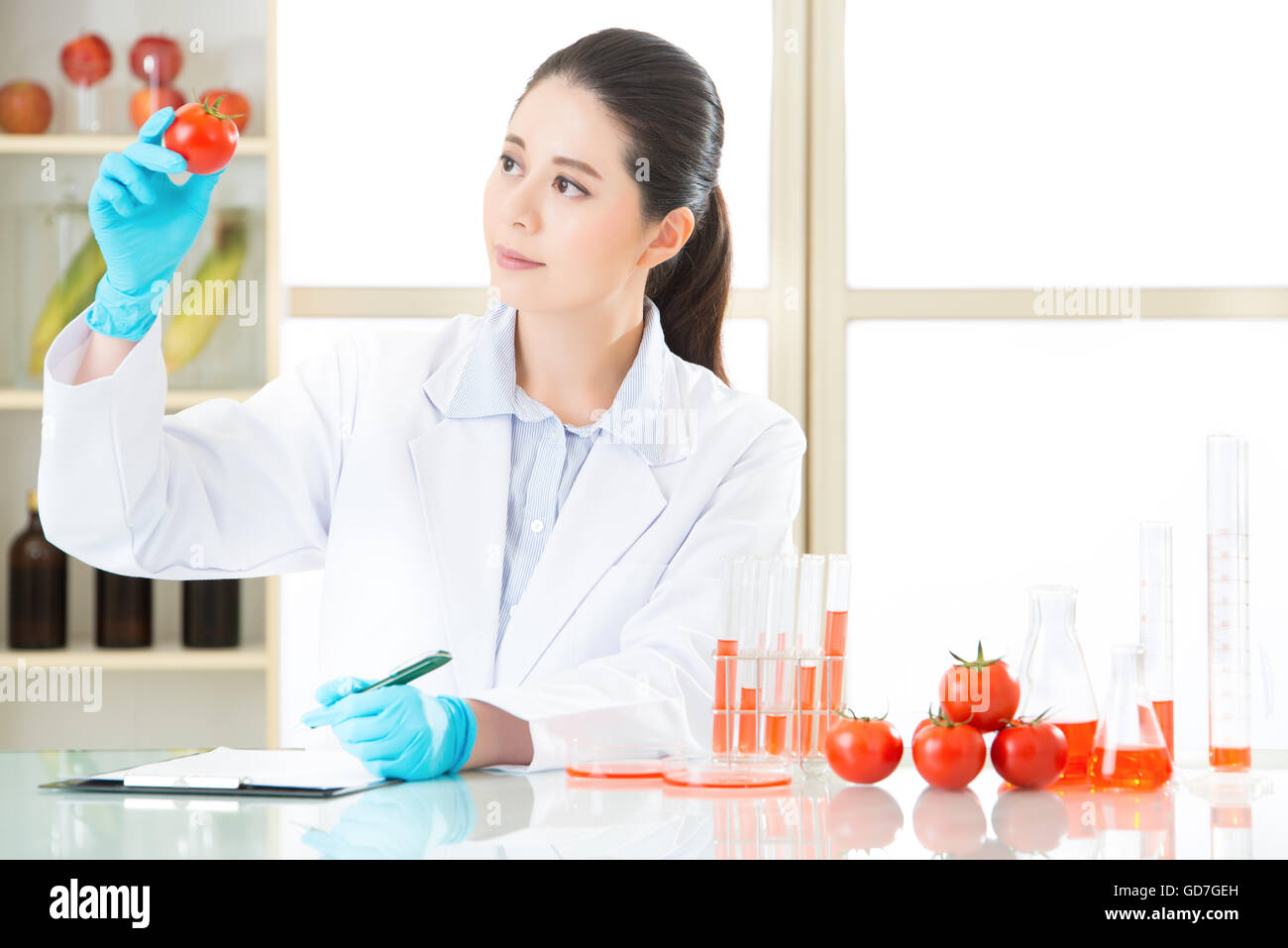 scientist looking the tube and recording science change for gmo food ...