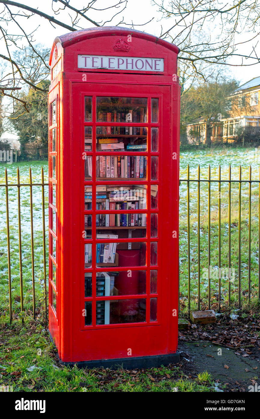 Red telephone box being used as a library in a village in England Stock ...