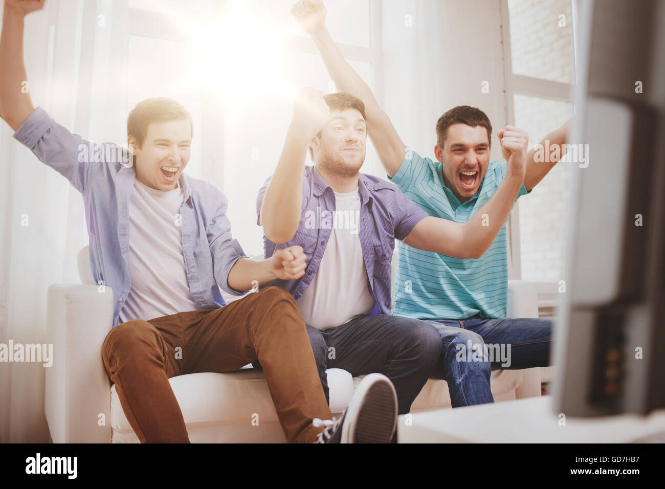 happy male friends at home Stock Photo - Alamy