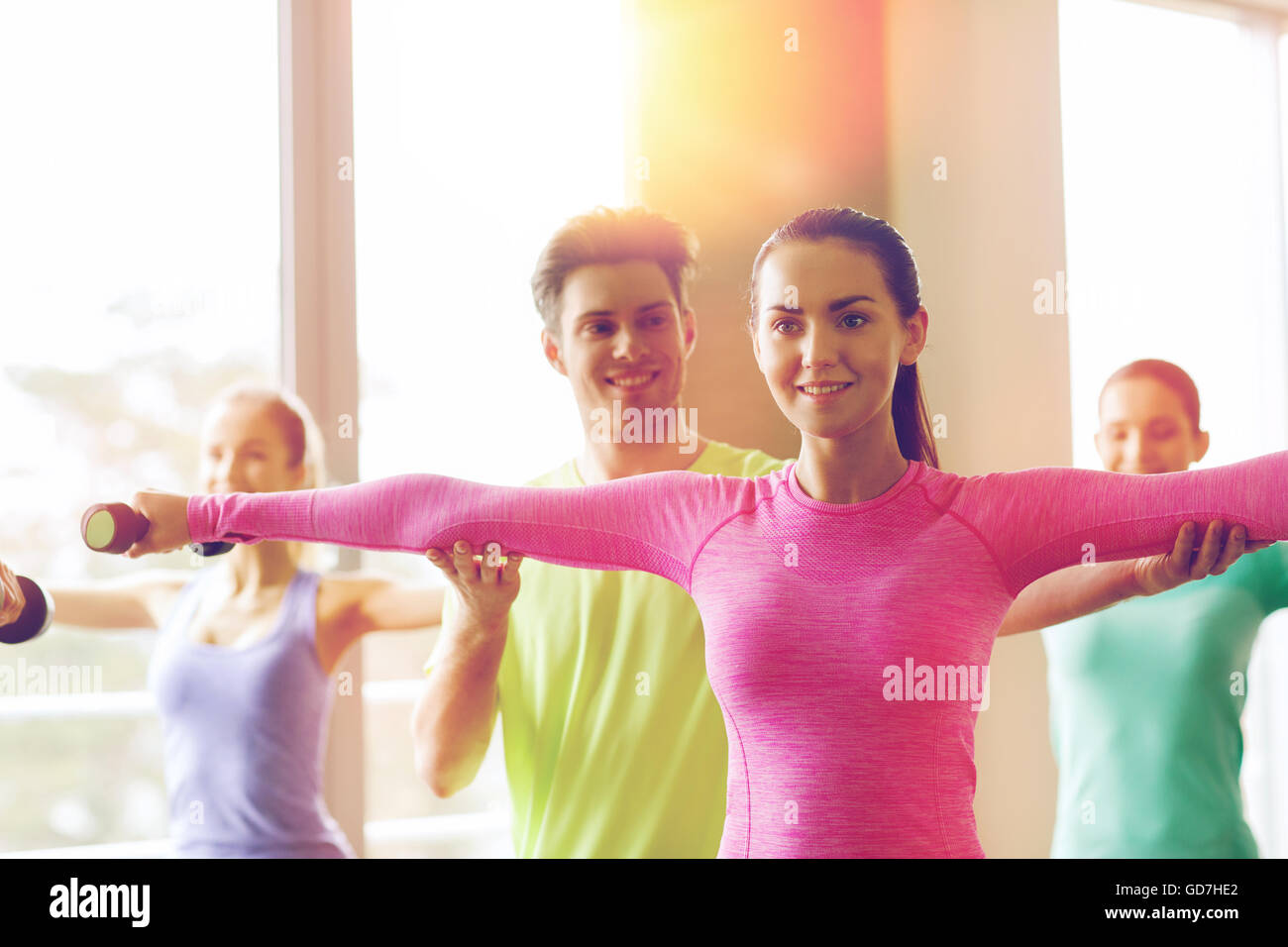 group of smiling people working out with dumbbells Stock Photo - Alamy
